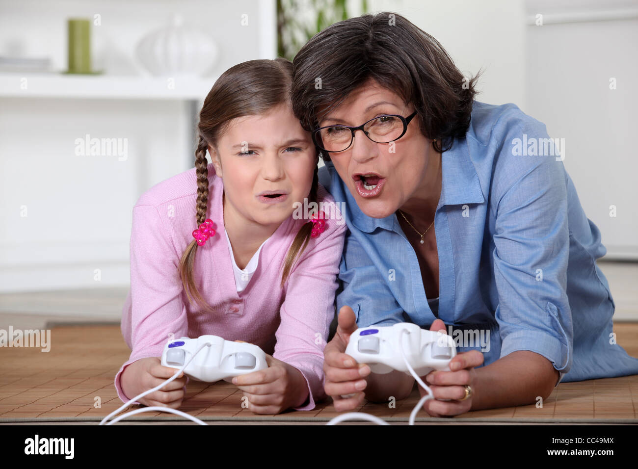 Little girl playing a computer game with her grandma Stock Photo - Alamy