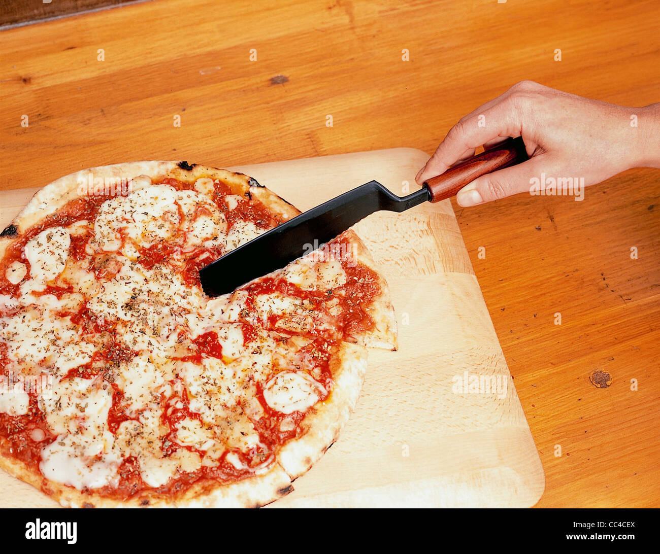 Using The Knife Pizza Stock Photo - Alamy