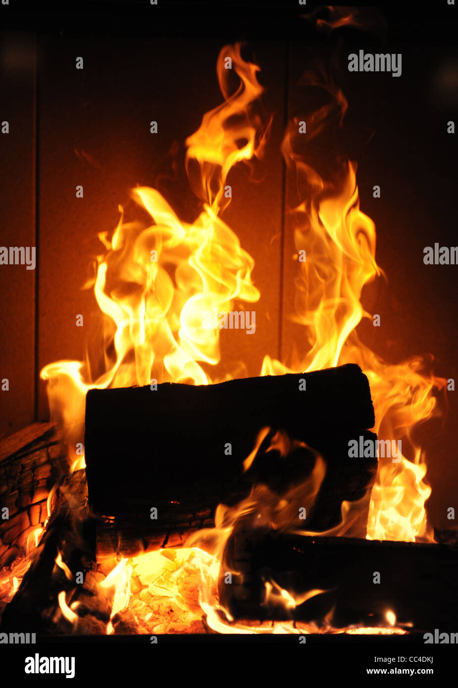 Logs burning on wood burner fire Stock Photo - Alamy