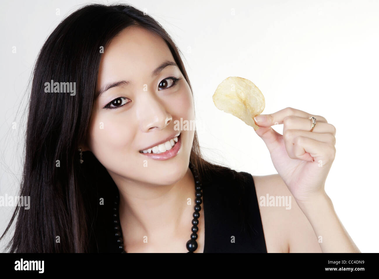 woman holding a single crisp looking happy Stock Photo - Alamy