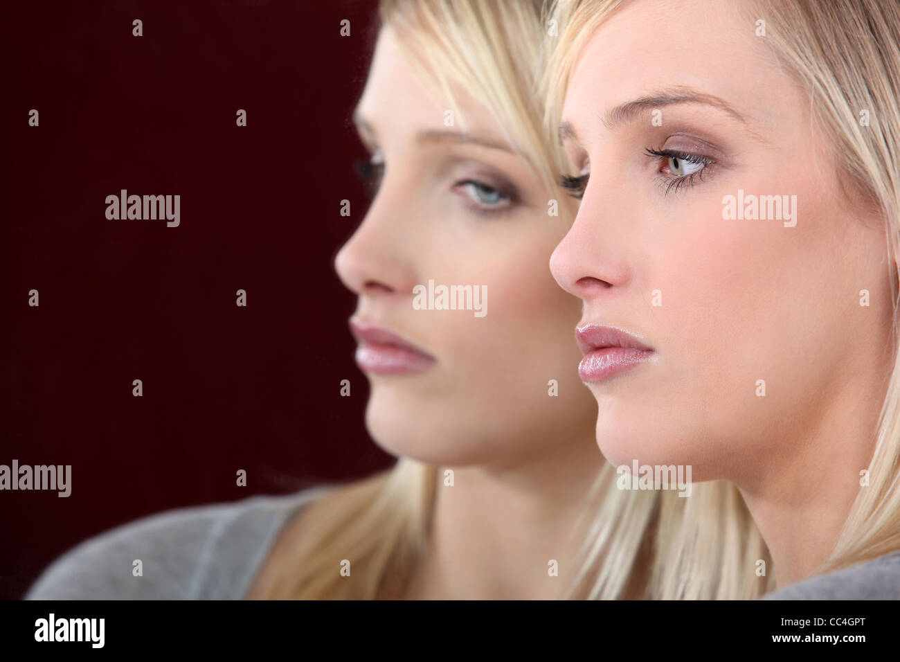 Sad woman looking in the mirror Stock Photo - Alamy