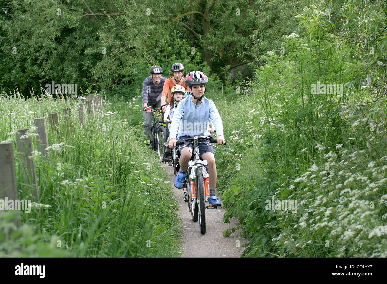 Cycling on cycle path children ride bike helmet hi-res stock ...