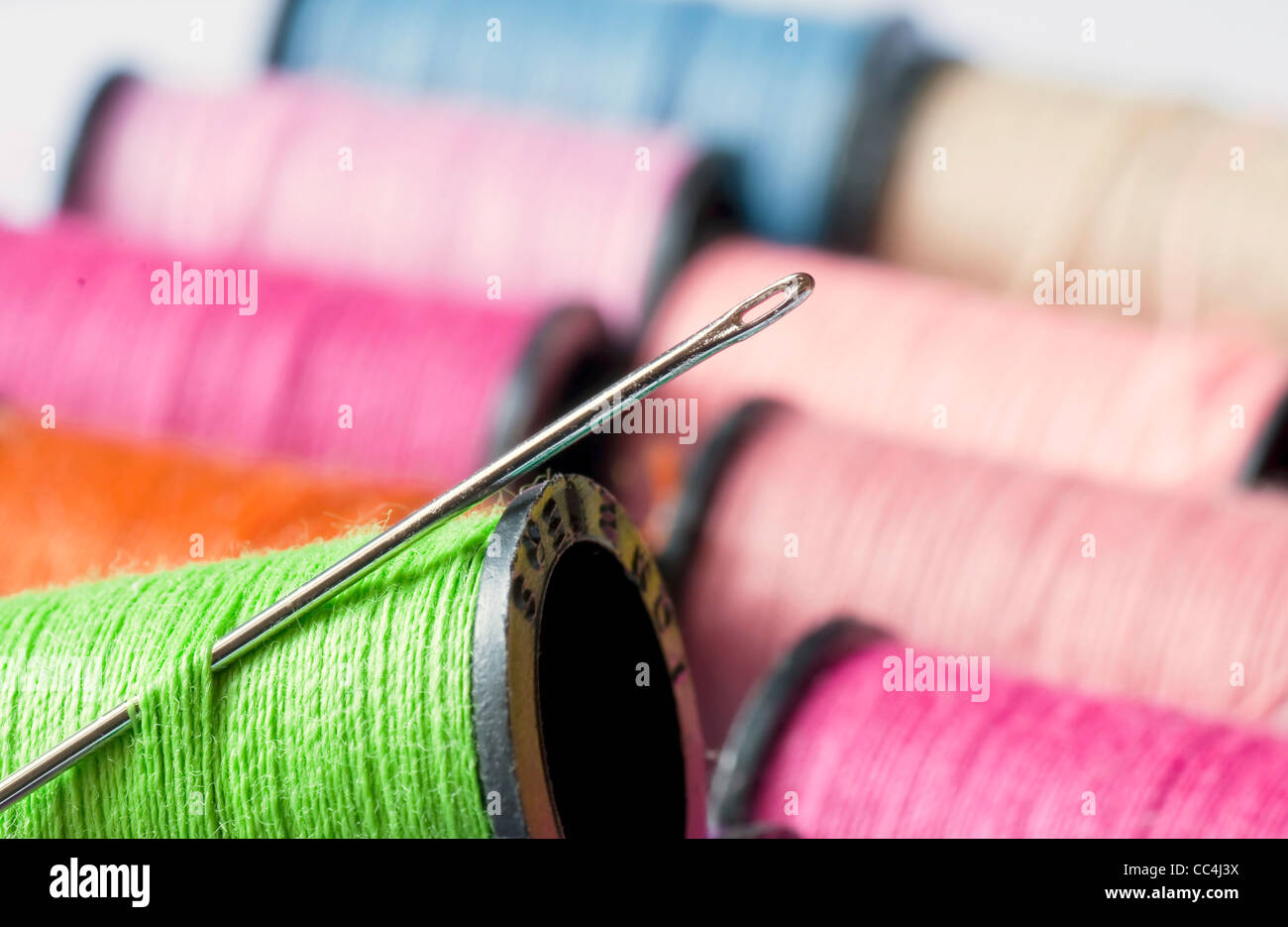 needle and cotton thread for sewing Stock Photo - Alamy