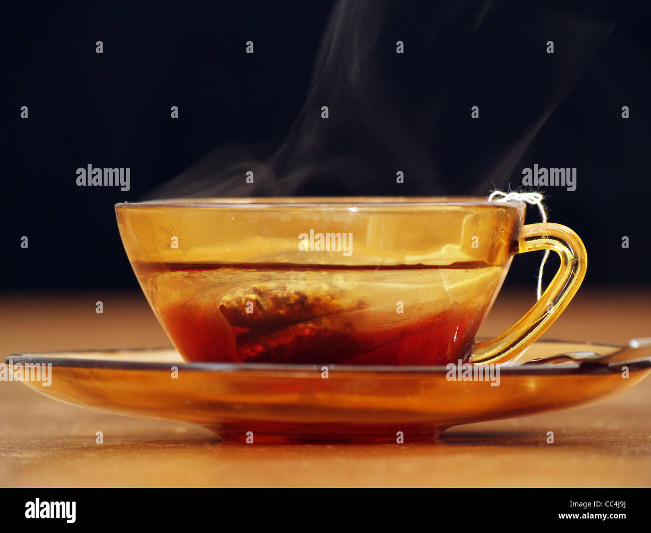 cup hot fruit tea drink black background steamy Stock Photo - Alamy