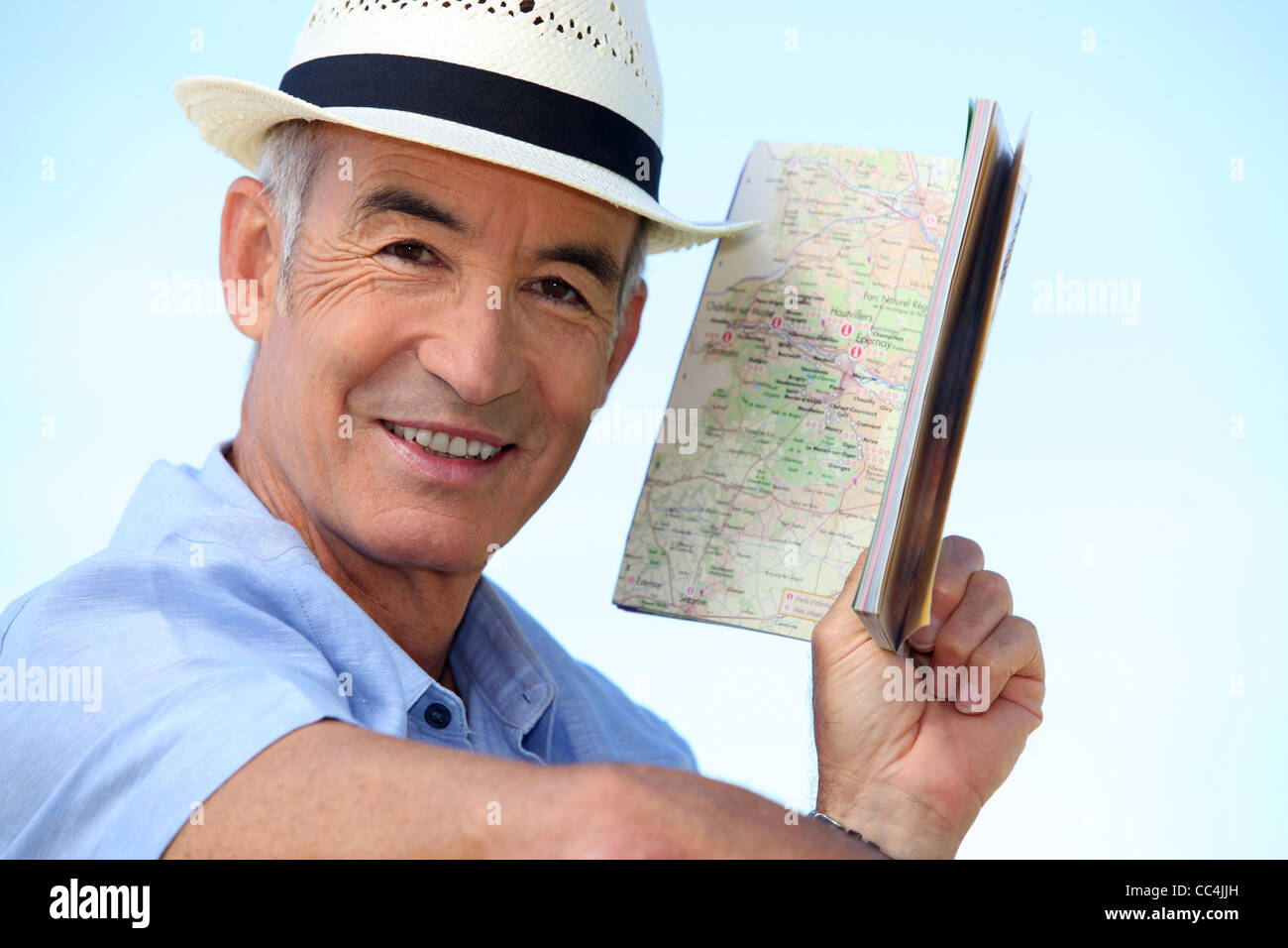 Man looking at an atlas Stock Photo - Alamy