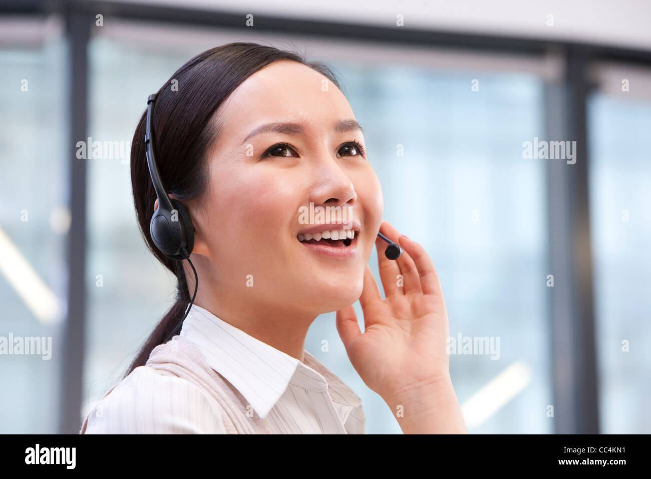 Smiling call center agent Stock Photo - Alamy