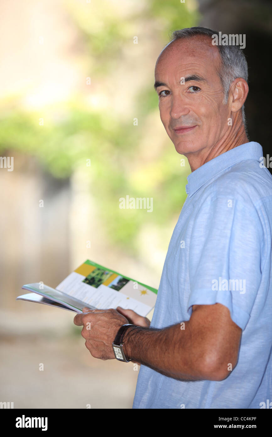 senior reading brochure Stock Photo - Alamy