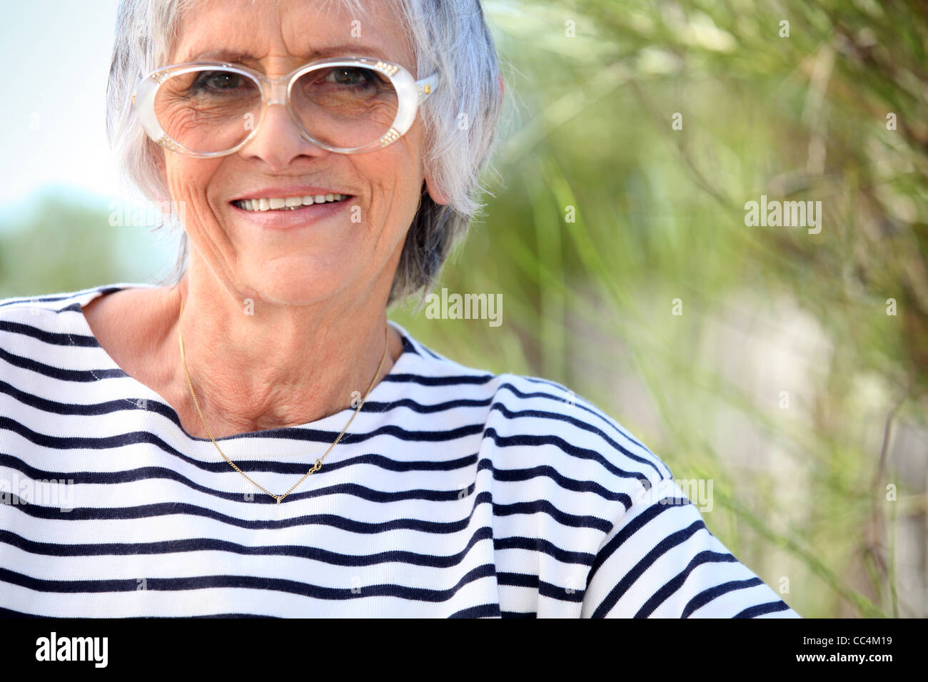 Elderly lady at the beach Stock Photo - Alamy