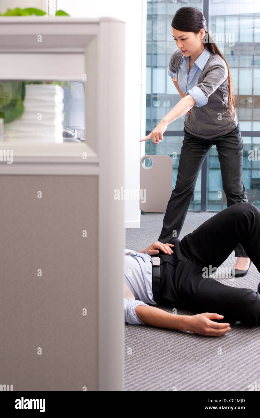 Businesswoman angrily pointing and accusing her colleague lying on the ...