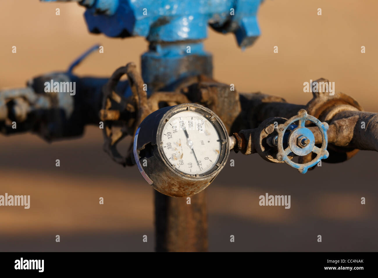 Close up of a gauge and valves on an oil well head on an oil well on ...