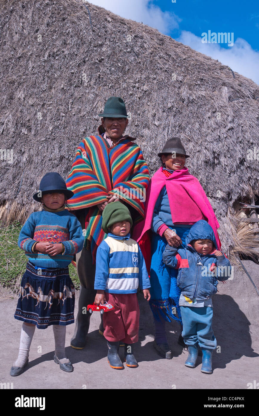 An Andean Indian family of five stand, facing forward, in front of ...