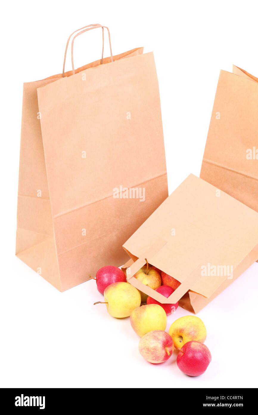 Shopping brown recycle gift bags and red apple isolated on white ...