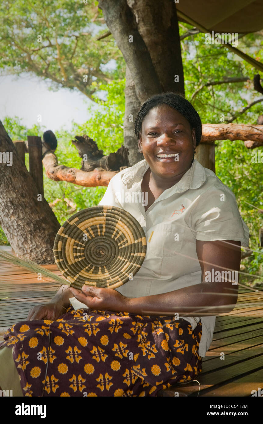 Africa Botswana Tuba Tree-Native woman holding basket she weaved Stock ...