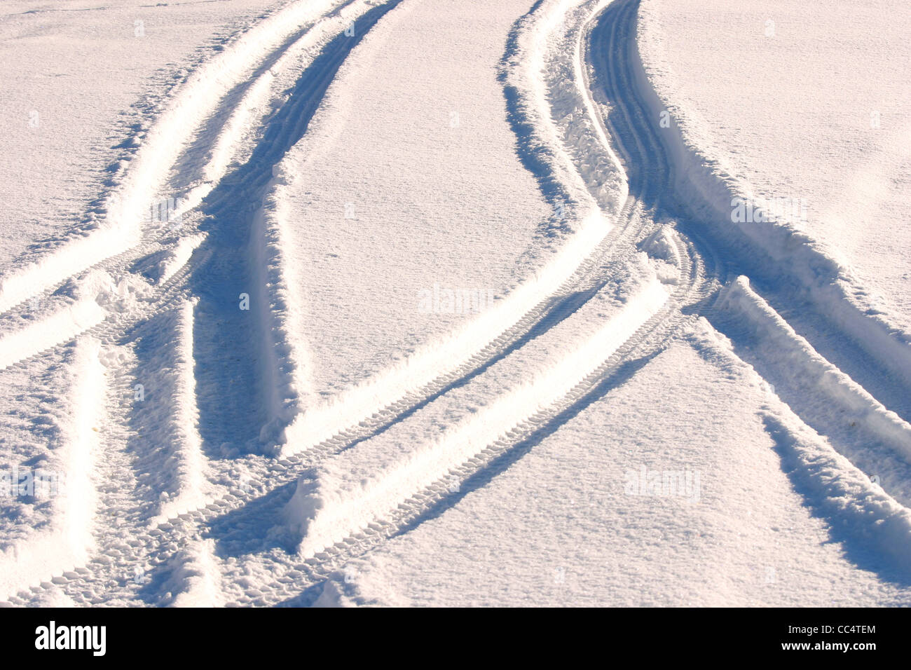 Sunshine on fresh snow showing snow tire tracks hi-res stock ...
