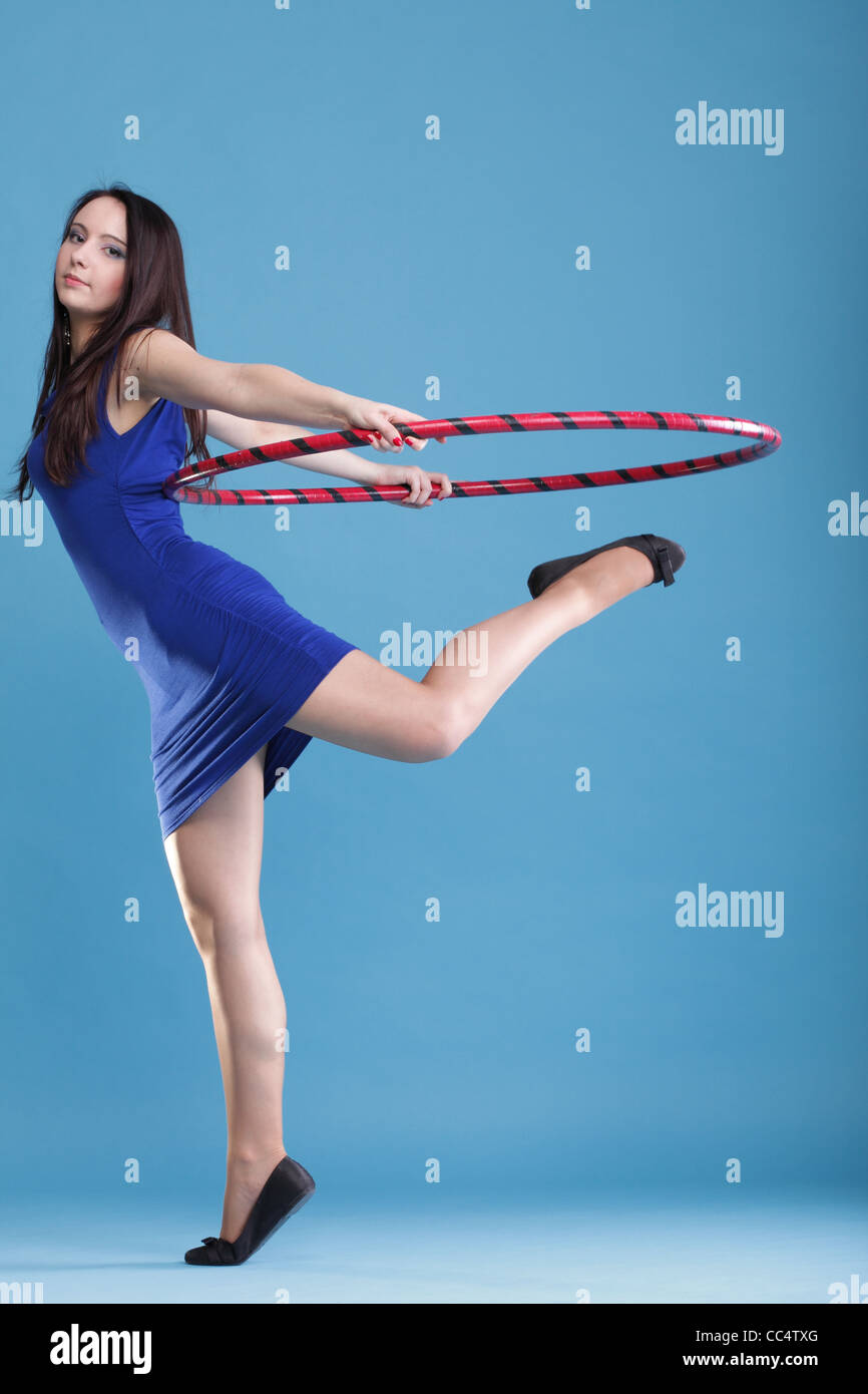 Beautiful woman in a sport wear. Dance hoop gym exercises blue ...