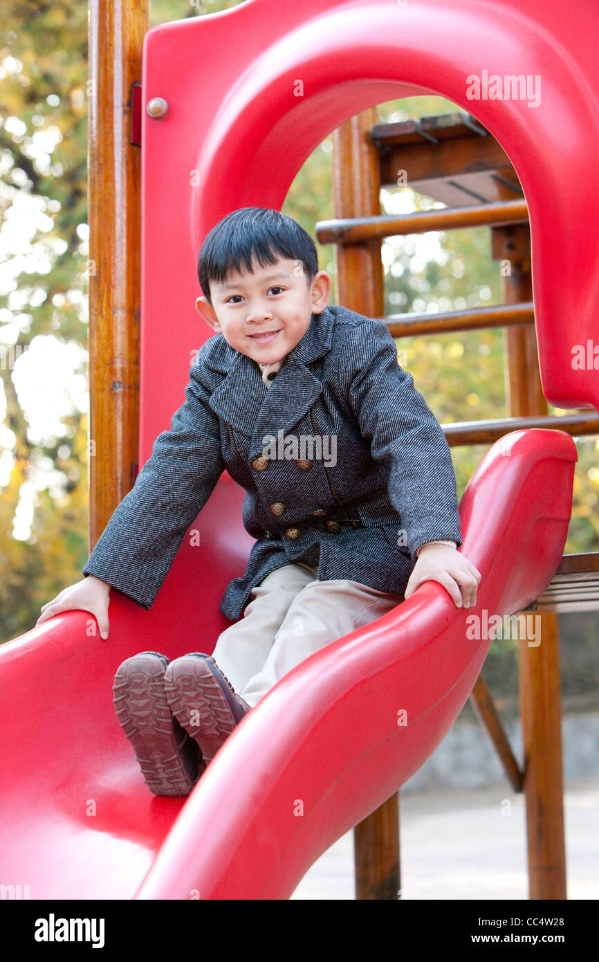 Boy on a slide Stock Photo - Alamy