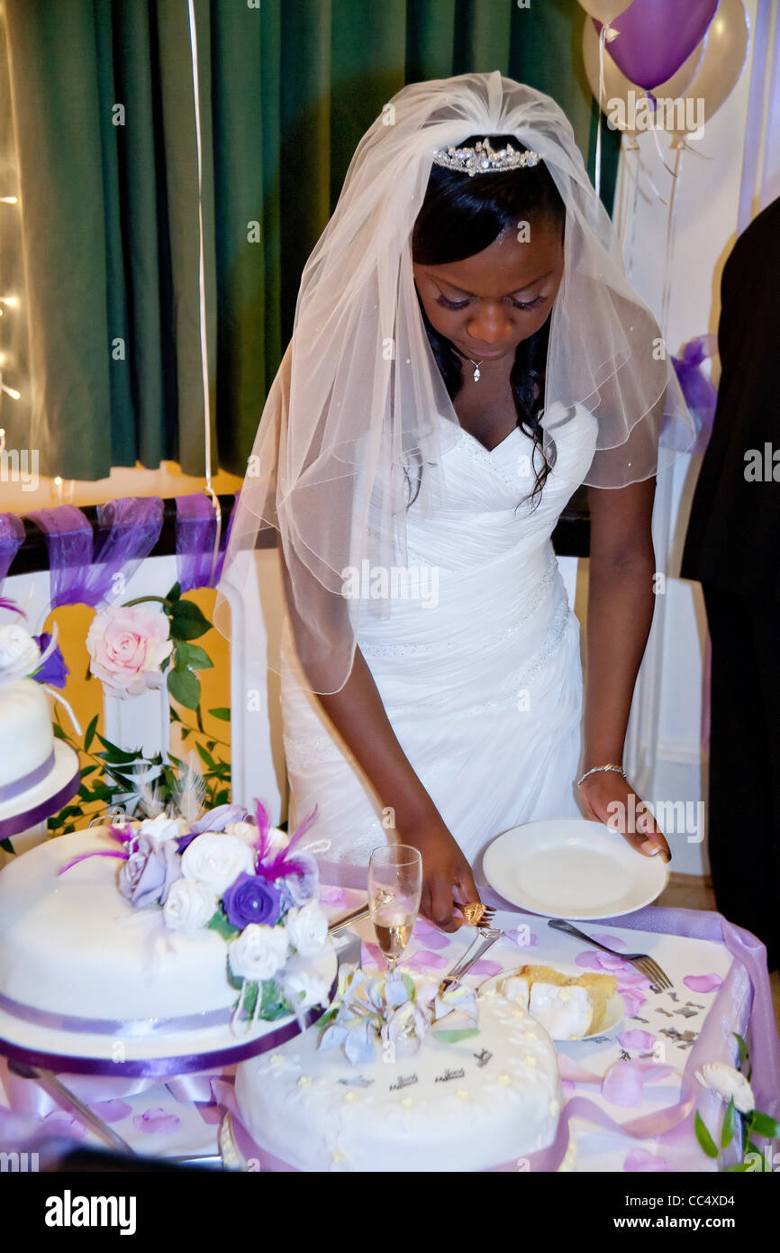 Bride serving wedding cake Stock Photo - Alamy