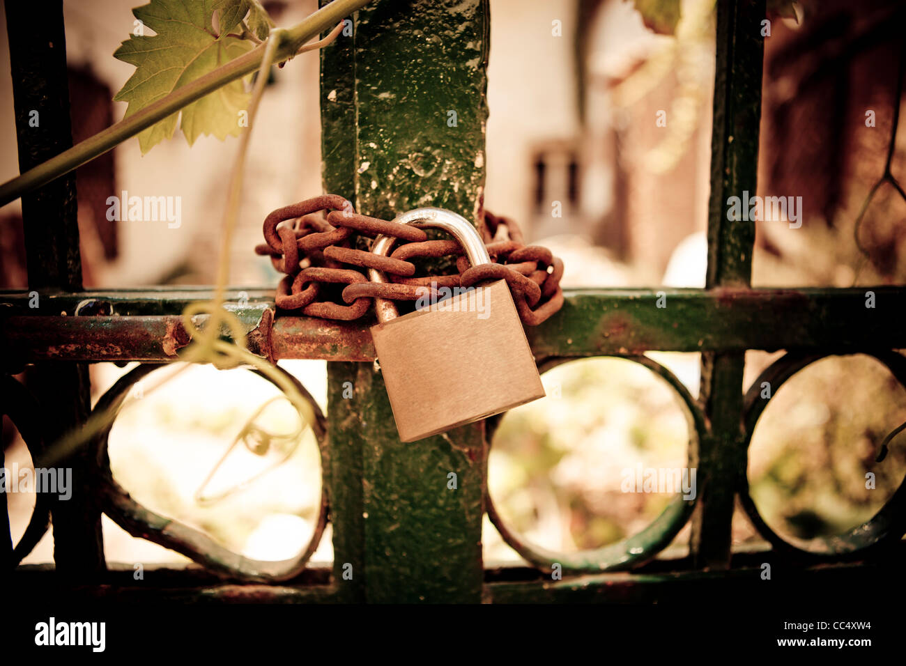 Lock with a rusted chain locking an iron gate Stock Photo - Alamy