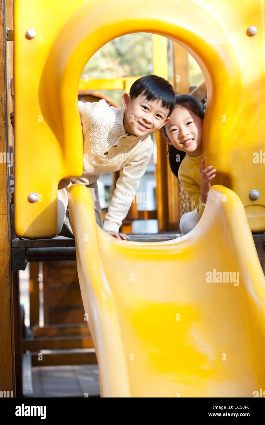 Children playing on playground slide Stock Photo - Alamy