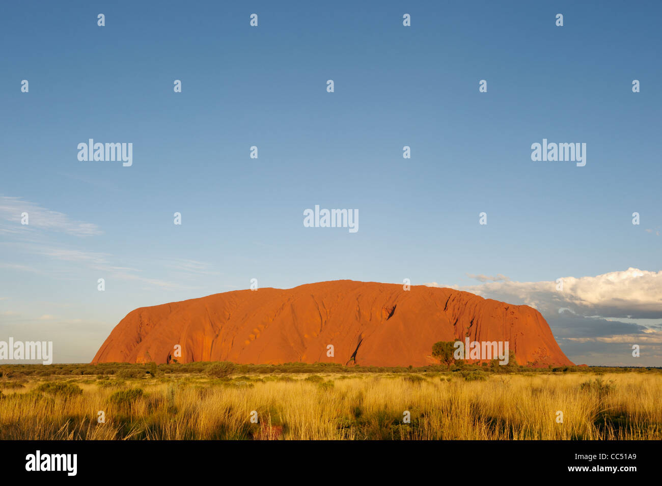 Sunset on Uluru; Ayers Rock glows orange under the setting sun, Uluru ...