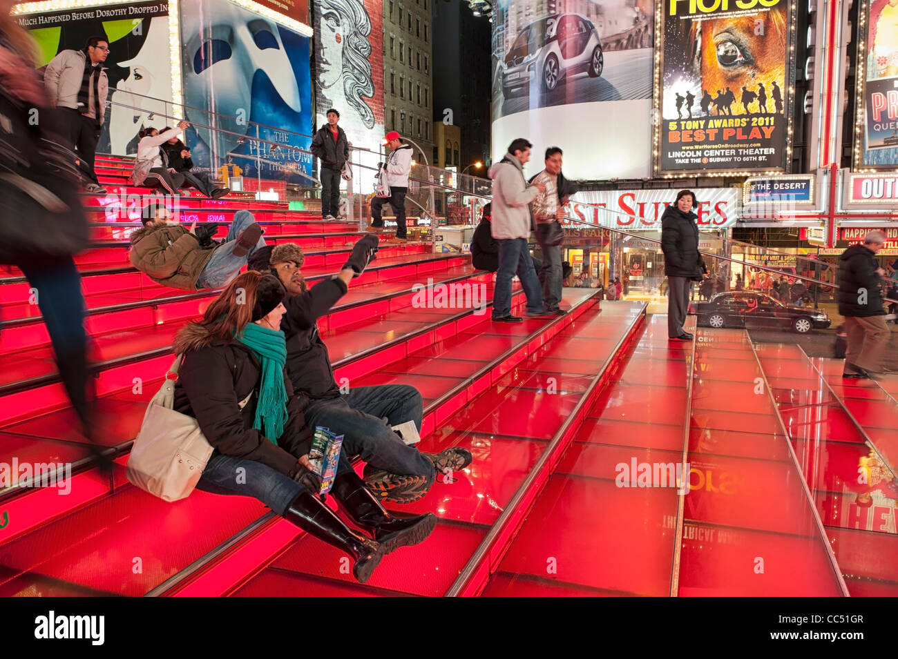Times Square TKTS big Red Stairway, visitors taking pictures, tourists ...
