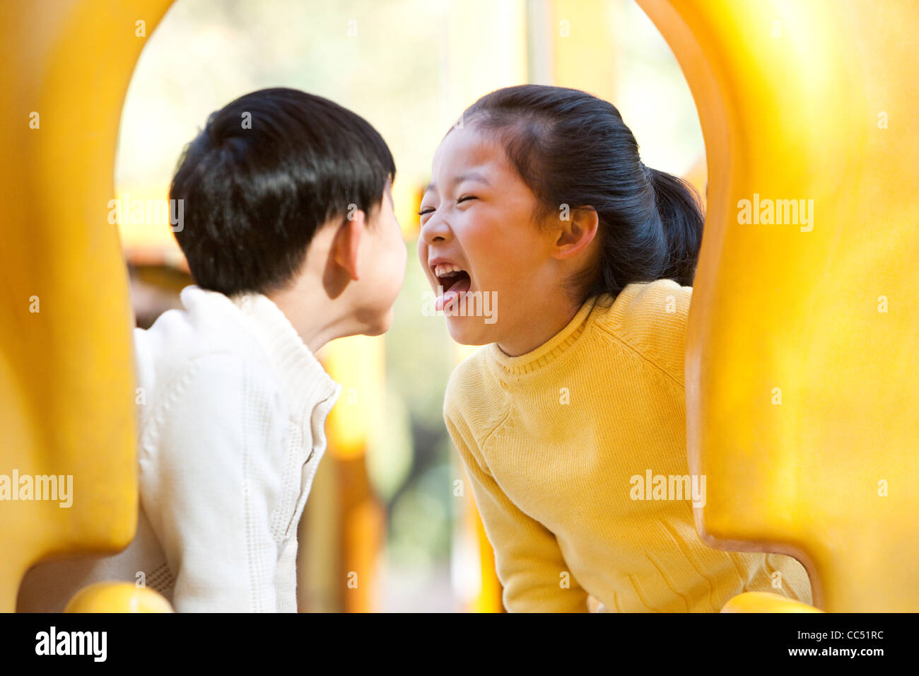 Children playing on playground slide Stock Photo - Alamy