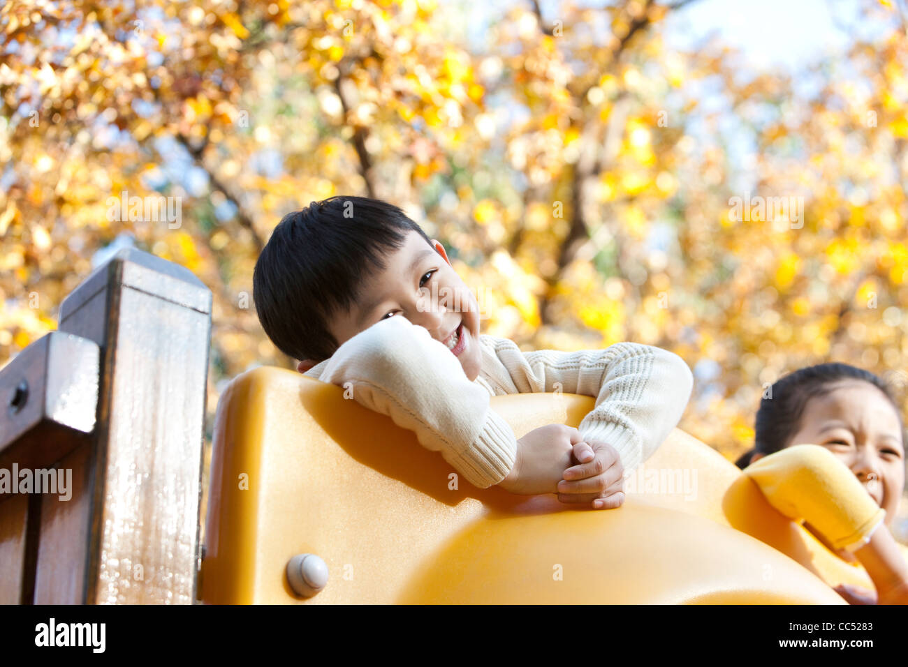 Children playing on playground slide Stock Photo - Alamy