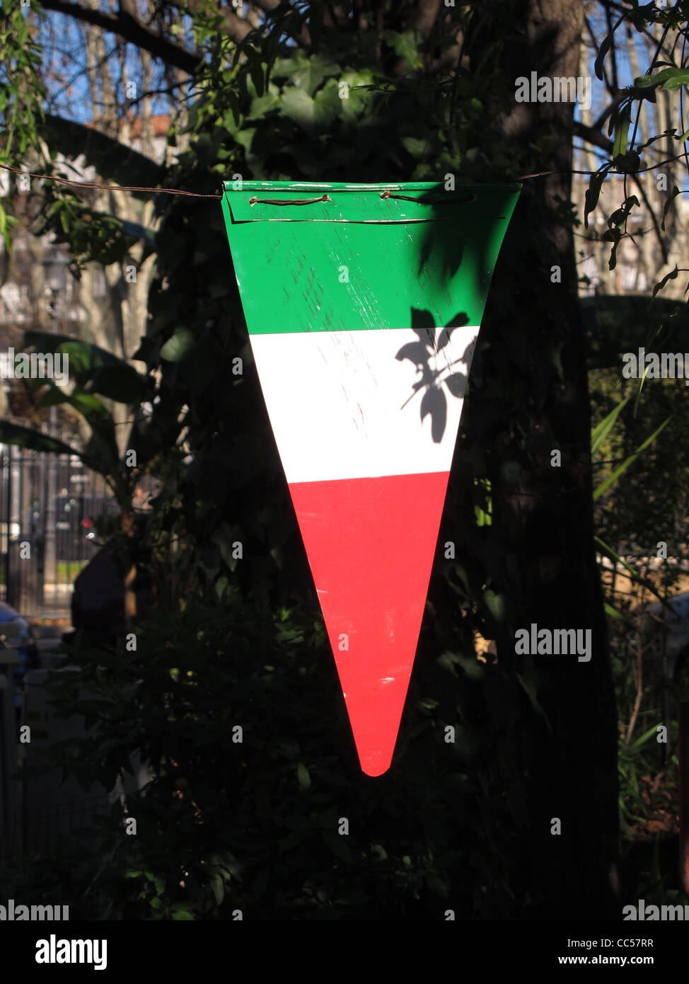 one triangular italian flag banner hanging in garden in rome italy ...