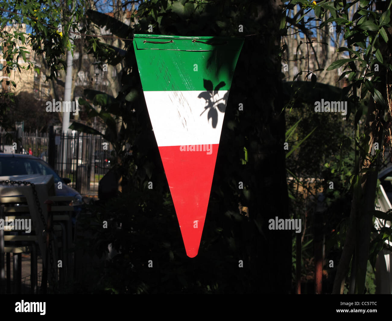 one triangular italian flag banner hanging in garden in rome italy ...