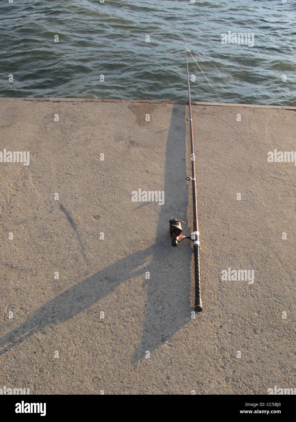 fishing road on sea wall Stock Photo - Alamy