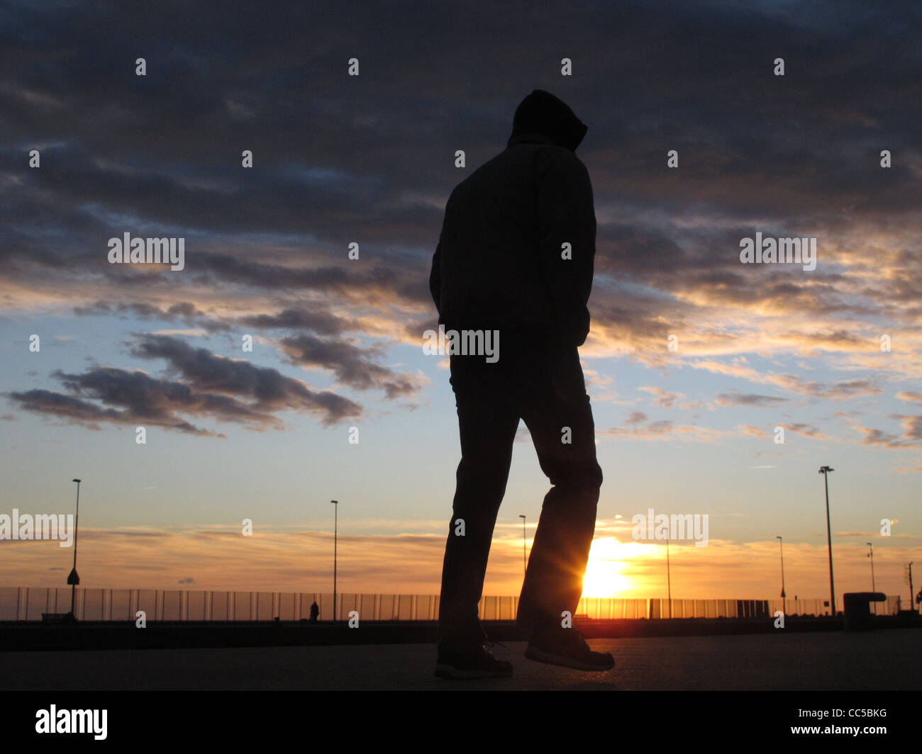 one single man silhouette by sea at sunset Stock Photo - Alamy
