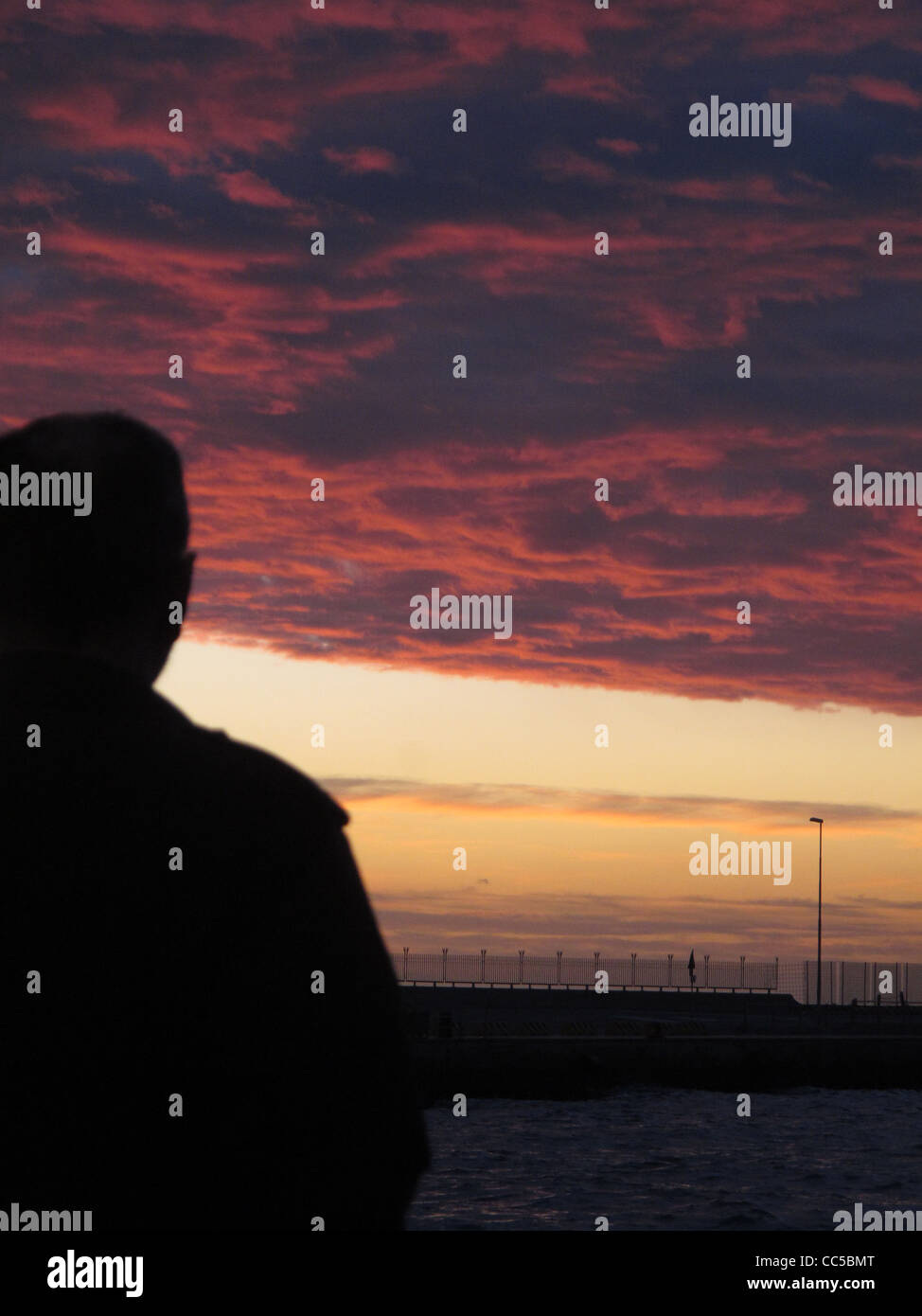 one single man silhouette by sea at sunset Stock Photo - Alamy