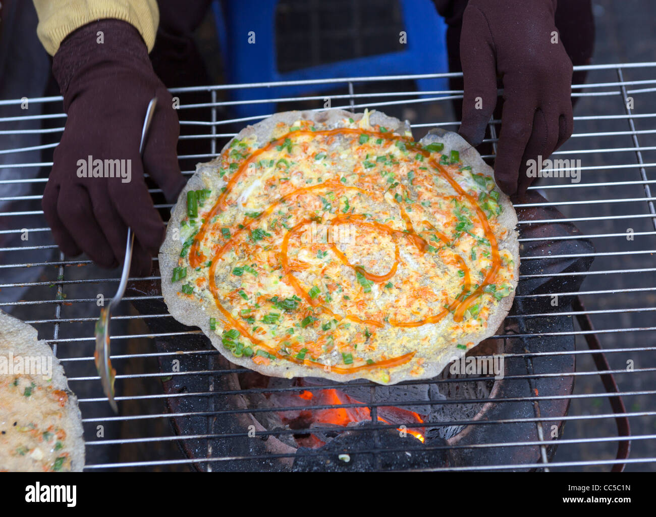 Grilling Rice Pancakes sold outside Central Market in Dalat Stock Photo ...
