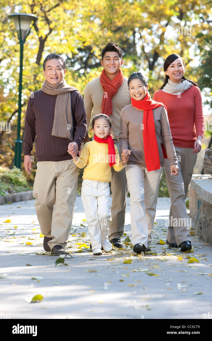 Family strolling through the park in Autumn Stock Photo - Alamy