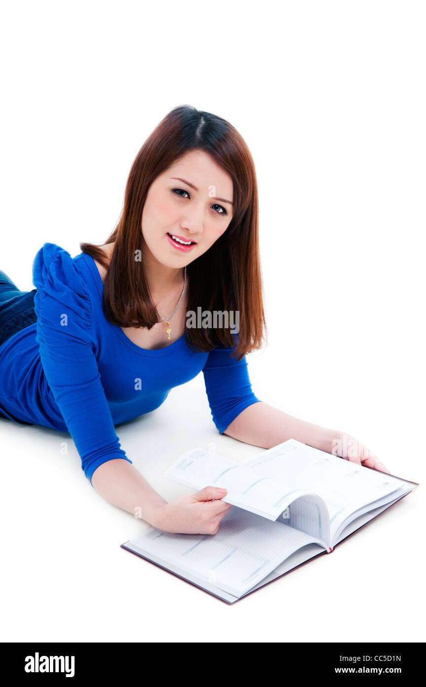 Attractive student flipping her book Stock Photo - Alamy