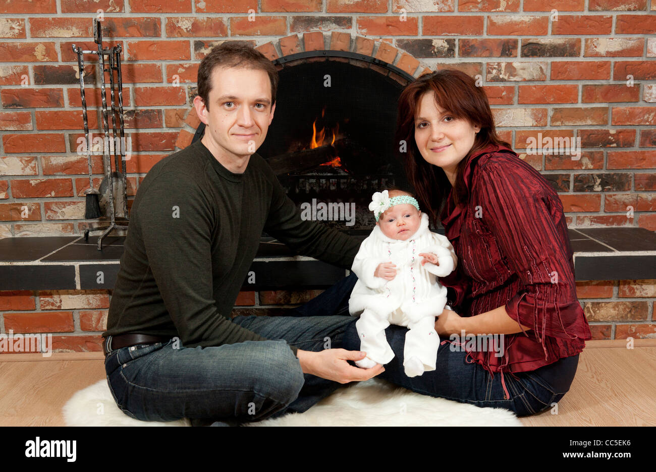 Family portrait by the fireplace Stock Photo - Alamy