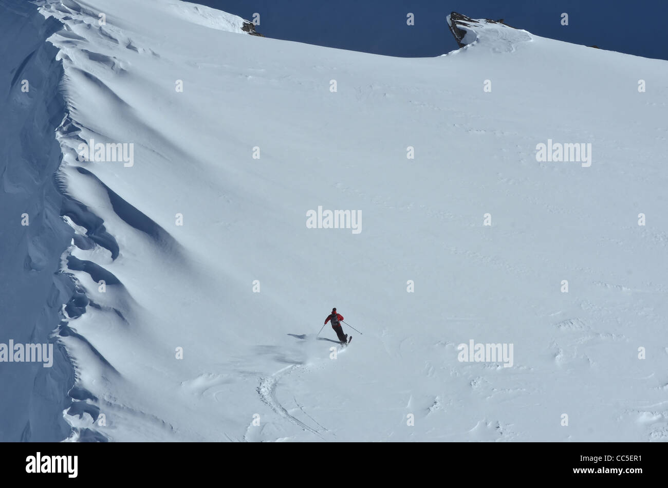 High mountain skiing on fresh powder in extreme conditions Stock Photo ...