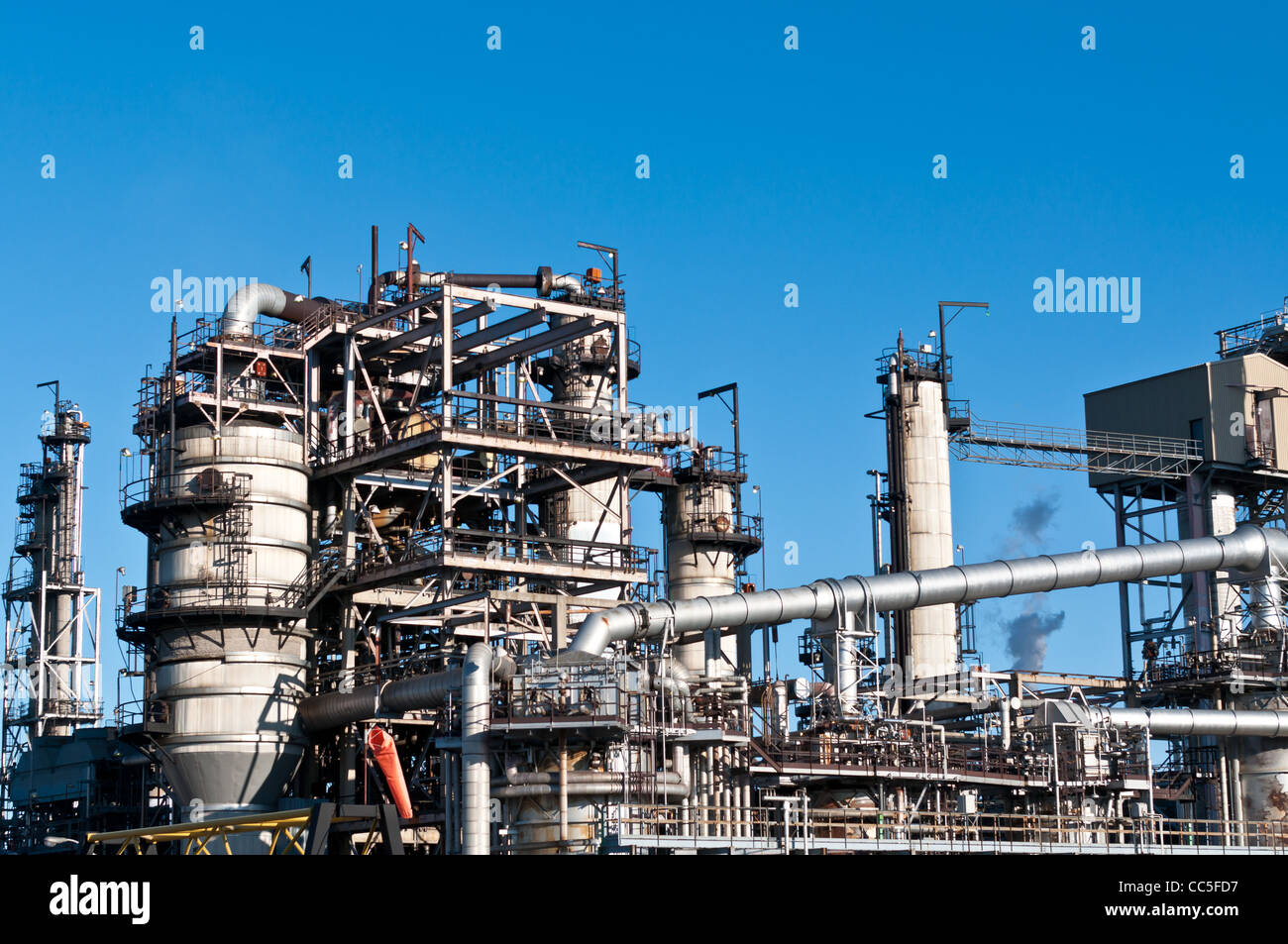 A petrochemical refinery plant with pipes and cooling towers Stock ...