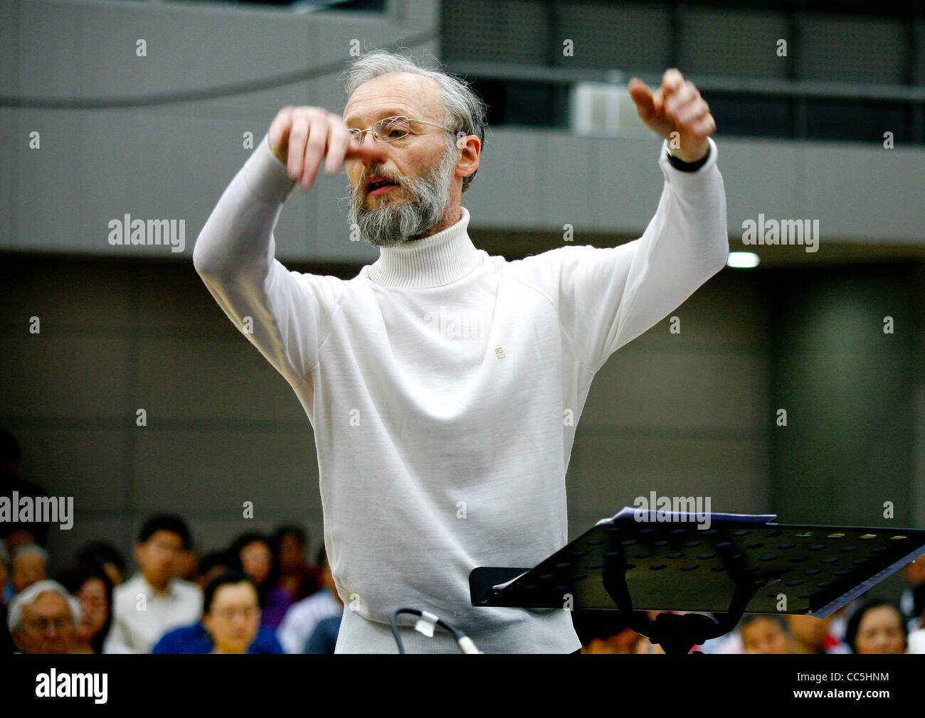 Music conductor raising his arms, Beijing, China Stock Photo - Alamy