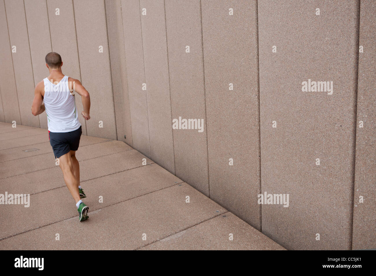 A man takes an early morning run around the Sydney Opera House, Sydney ...