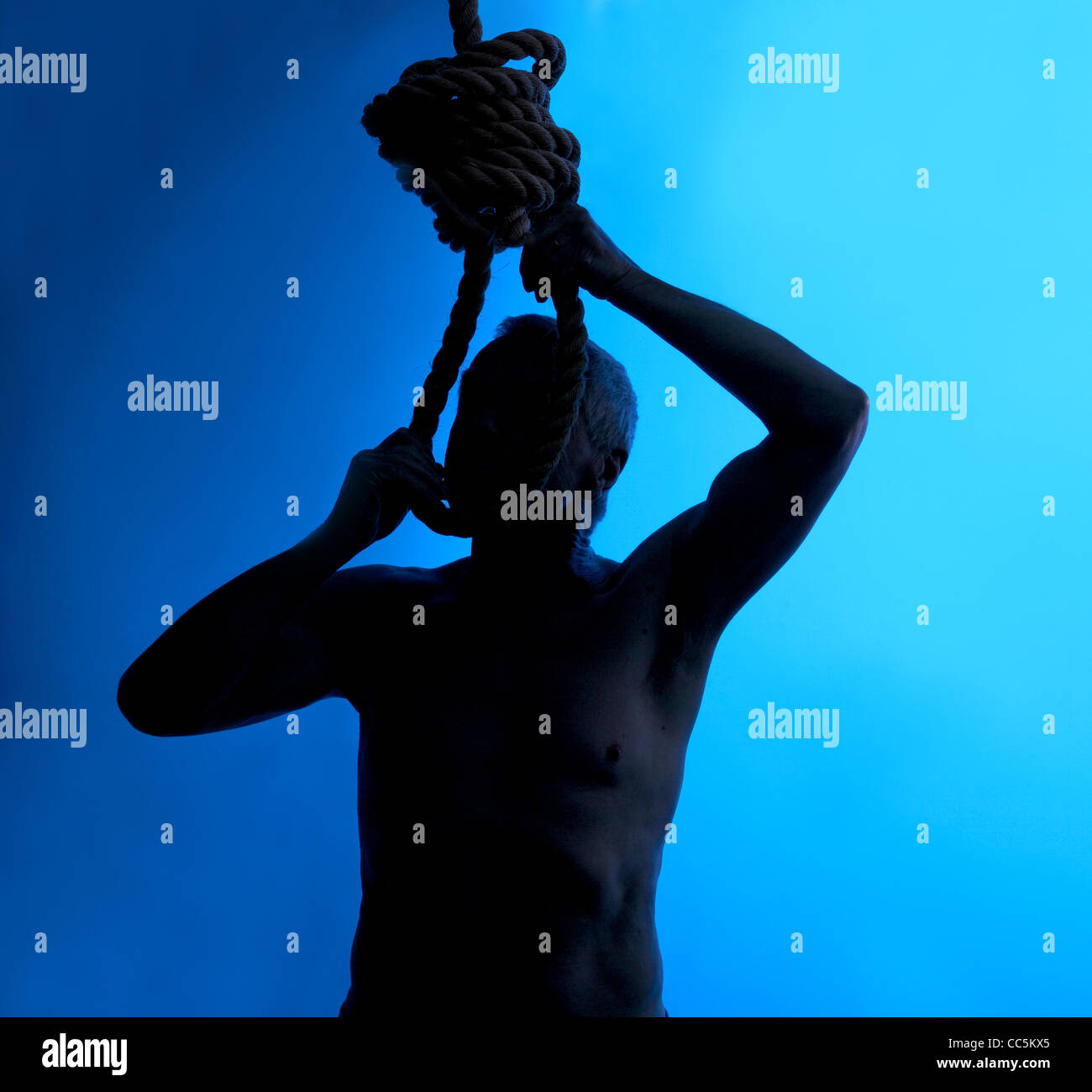 A silhouette of a man placing a noose around his neck Stock Photo - Alamy