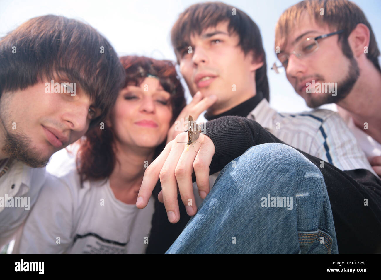 Four friends with butterfly Stock Photo - Alamy