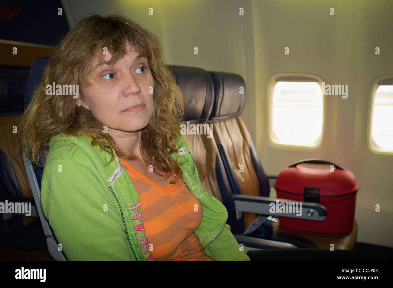 Woman traveling by airplane Stock Photo - Alamy