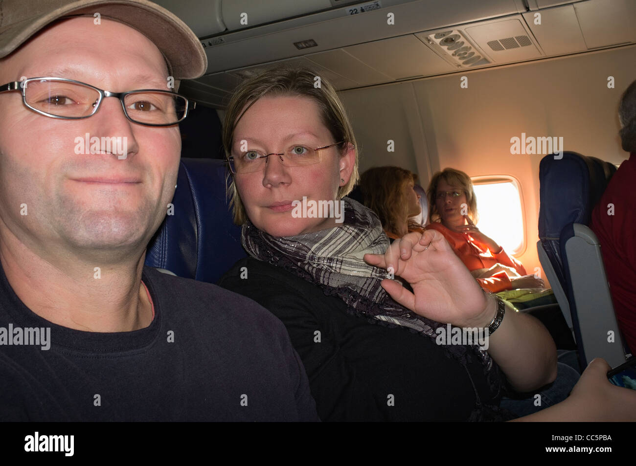 People in economy class cabin airplane enjoying flight Stock Photo - Alamy