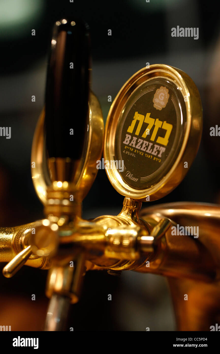 A beer tap displays the Israeli Bazalet microbrewery beer logo Stock ...