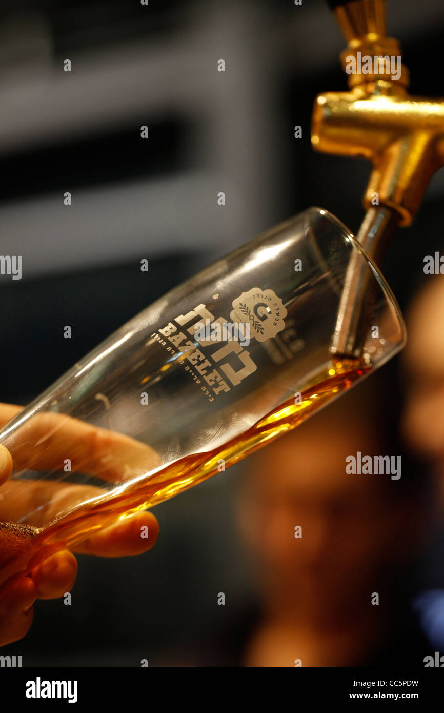 A beer glass displays the Israeli microbrewery Bazelet beer logo Stock ...