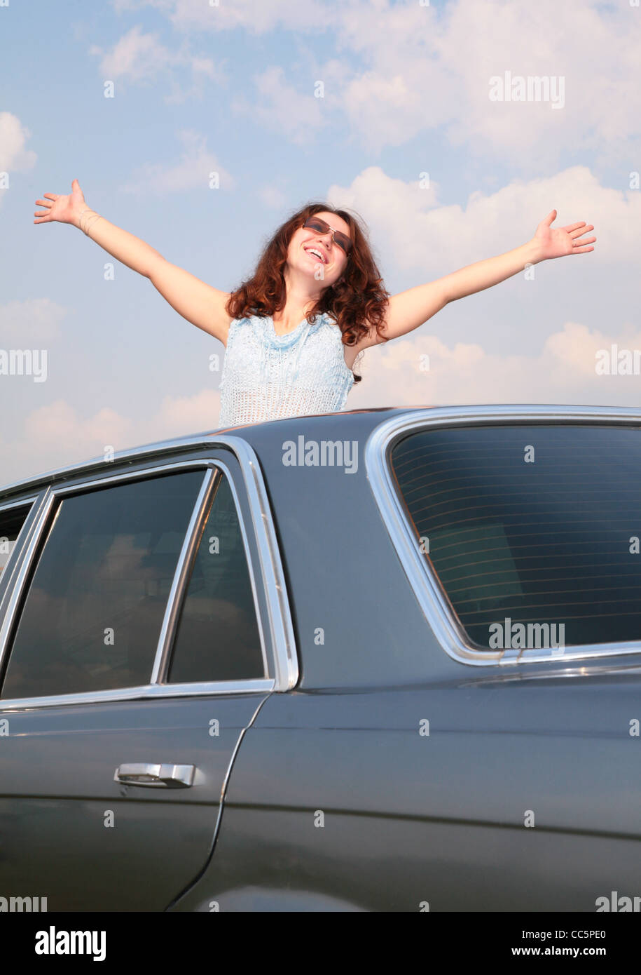 Girl with raised hands and car Stock Photo - Alamy