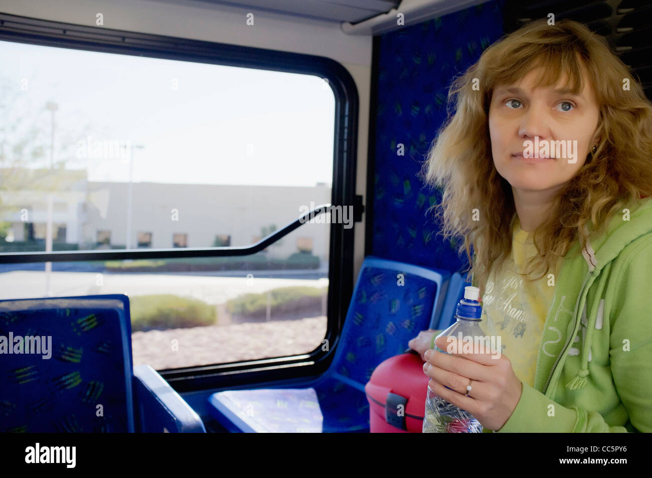 Woman taking a bus ride for transportation Stock Photo - Alamy