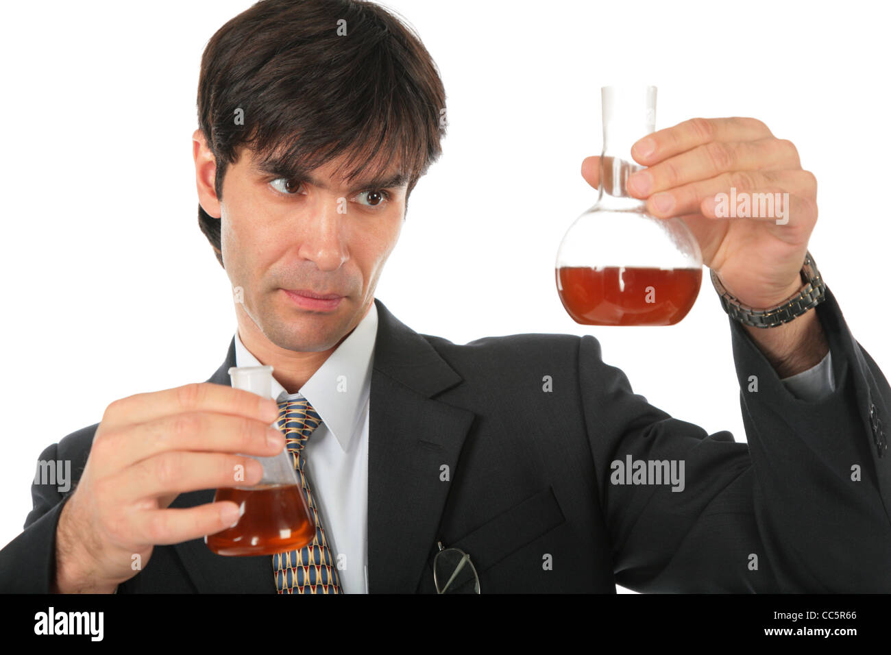 Scientist with two flasks with brown liquid Stock Photo - Alamy