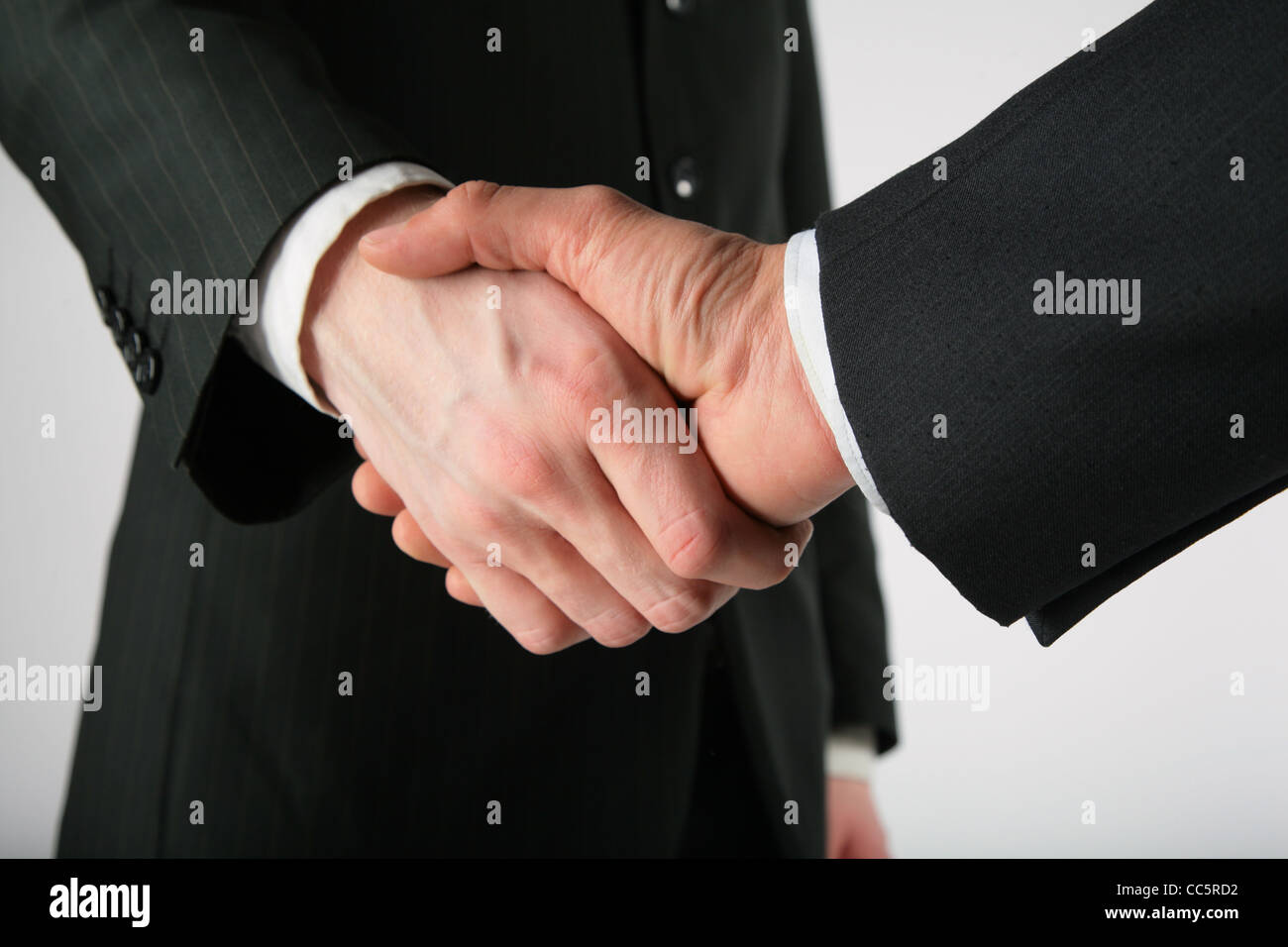 Two men handshake Stock Photo - Alamy